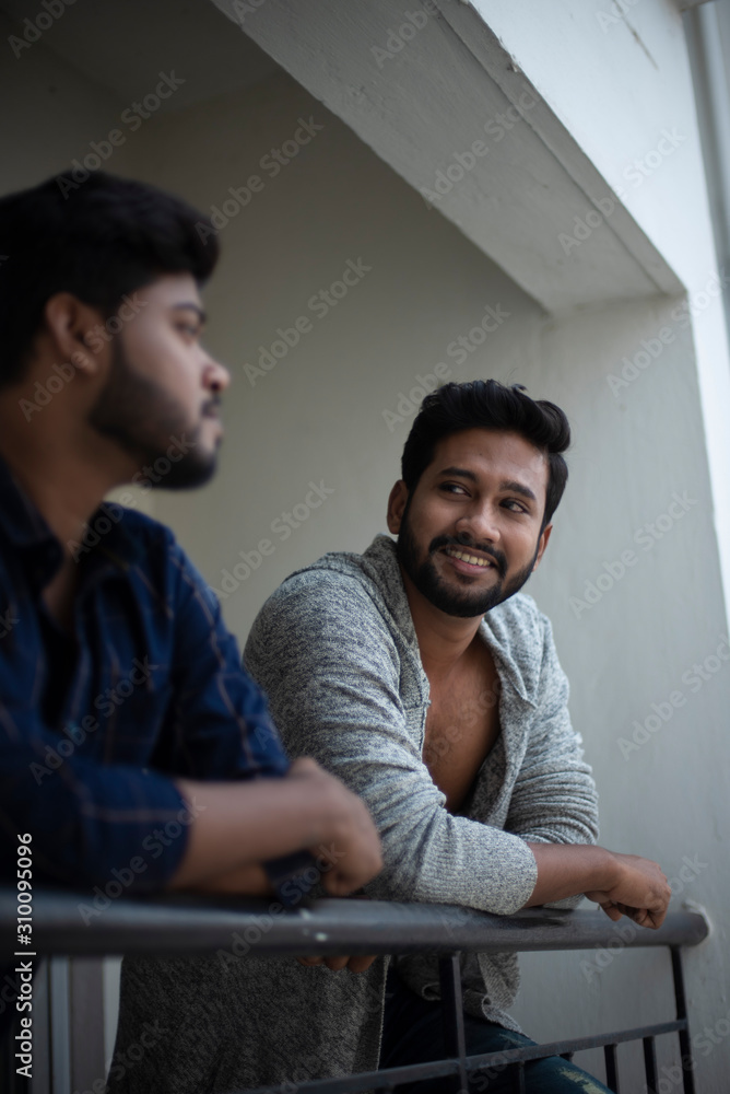 Two young tall, dark and handsome Indian Bengali men in western jackets ...