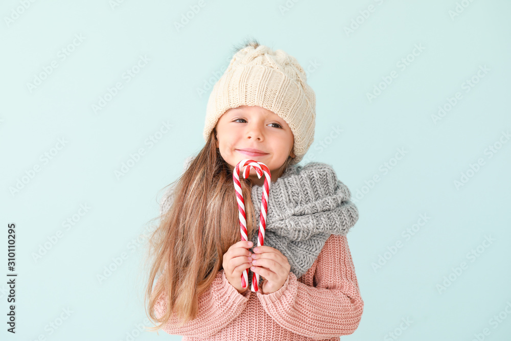 Cute little girl with sweet candy canes on color background Stock Photo ...