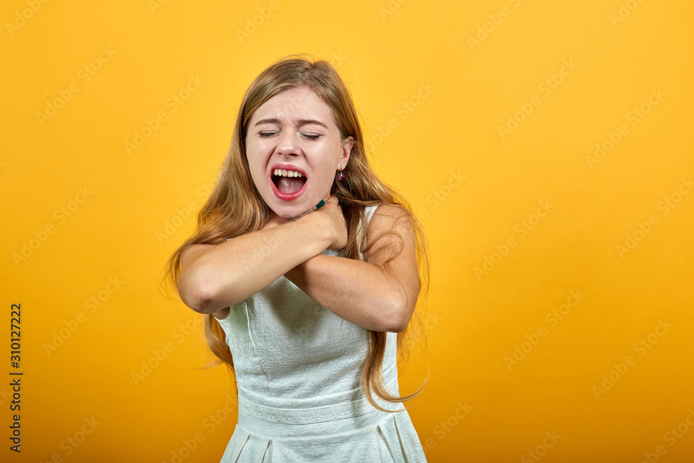 Charming caucasian blonde young woman keeping hands on neck, choking ...