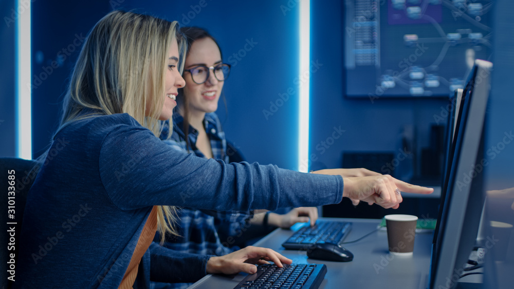 Two Female IT Programers Working on Desktop Computer in Data Center ...