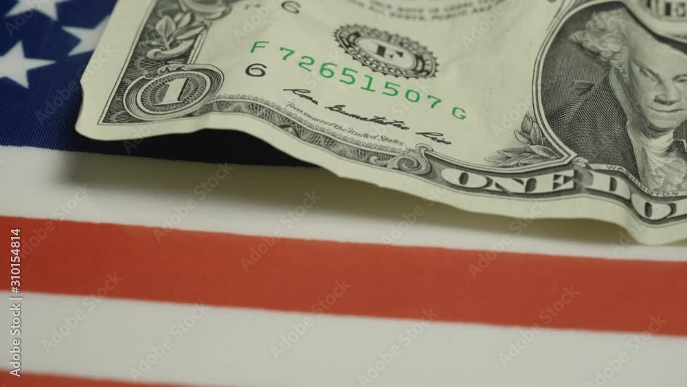 dented one dollar banknote with numbers and symbols lies on American ...