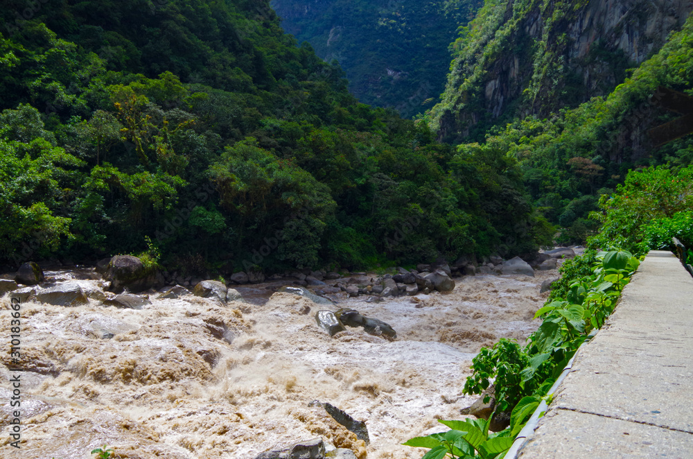 Roaring and powerful rapids of Urubamba River in valley between ...