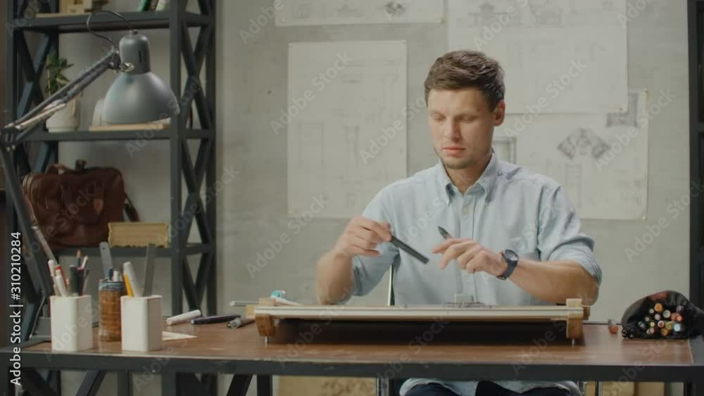 architect man Standing working with blueprints sketching a construction ...