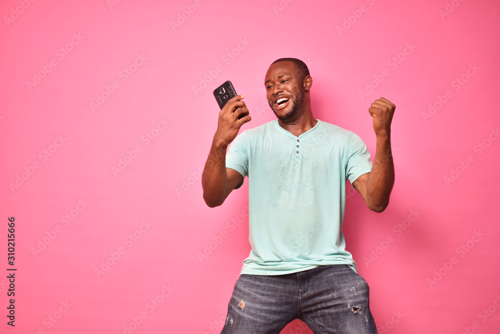 handsome excited young black man feeling excited while viewing content ...