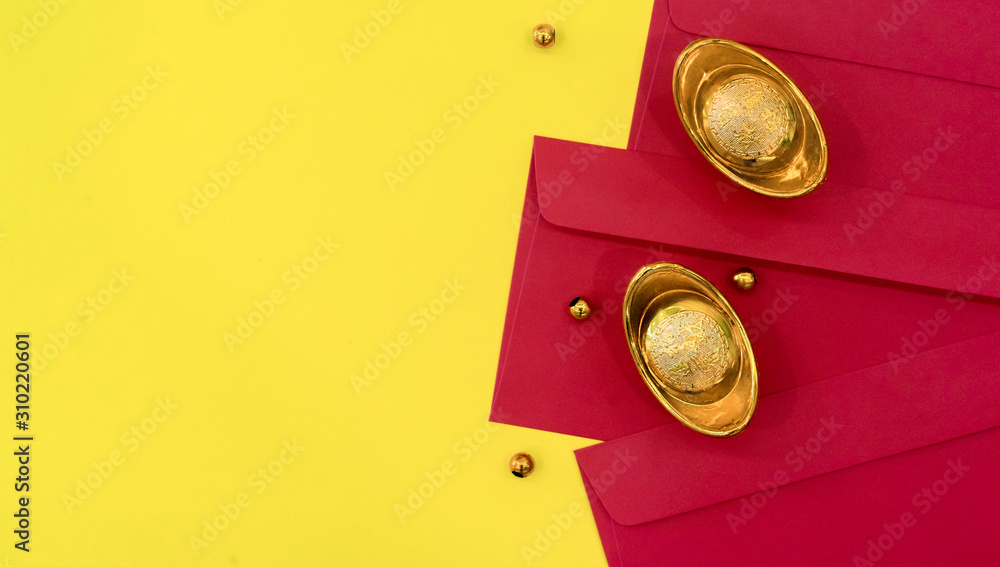 close up gold ingots and red envelope pocket (ang pao) over yellow ...