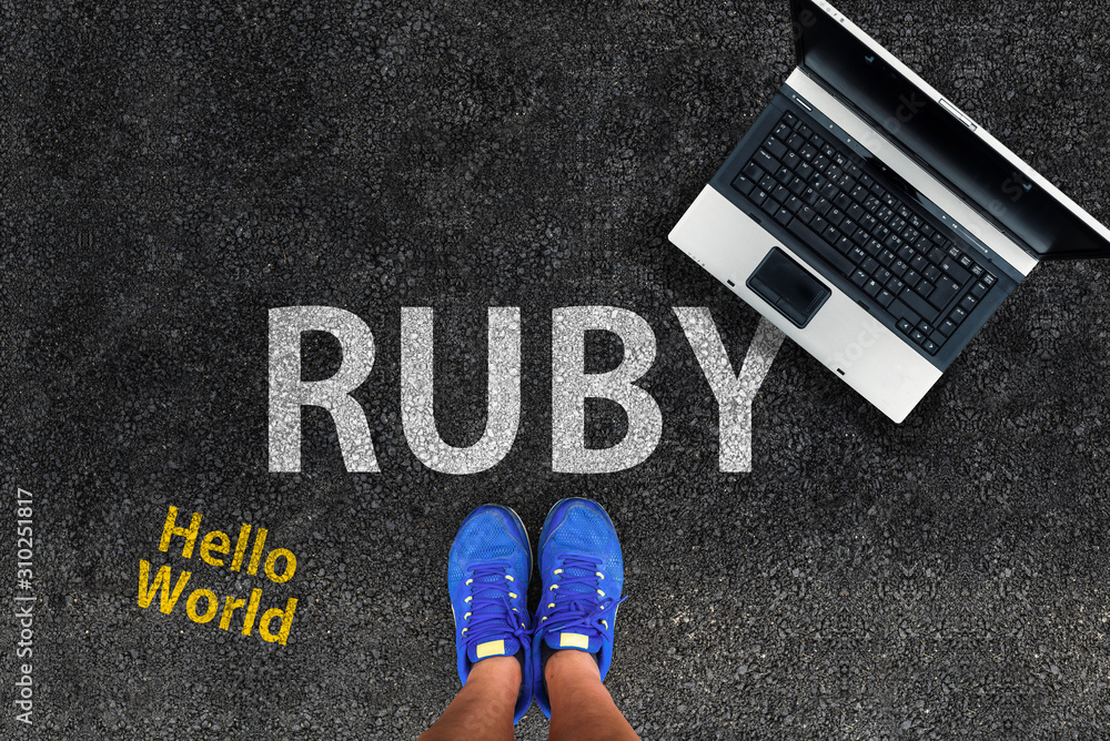 Ruby programming language. man legs in sneakers standing next to laptop ...