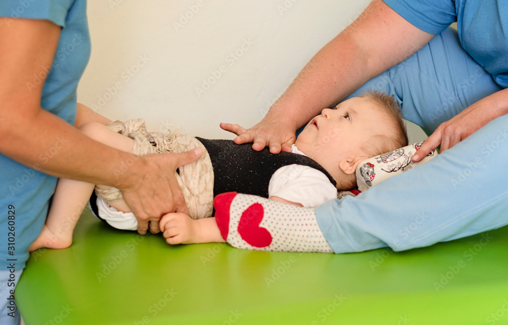 Portrait of a baby with cerebral palsy on physiotherapy in a children ...