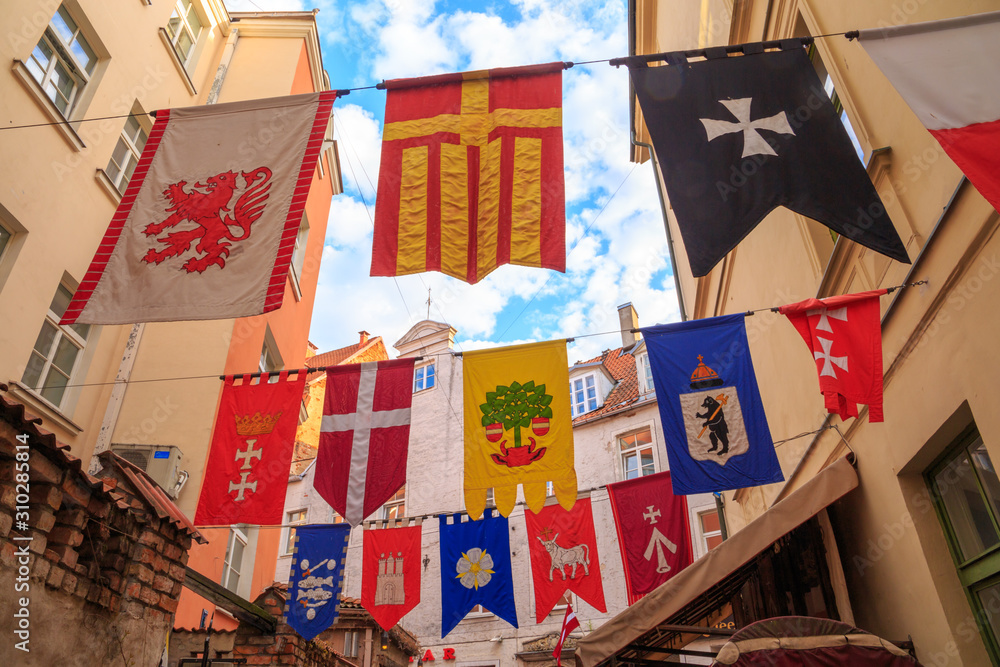 Colorful and decorative vintage flags from the middle age are hanging ...