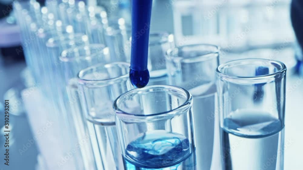 Pharmaceutics Laboratory: Pipette Dropping Blue Liquid into Test Tubes ...