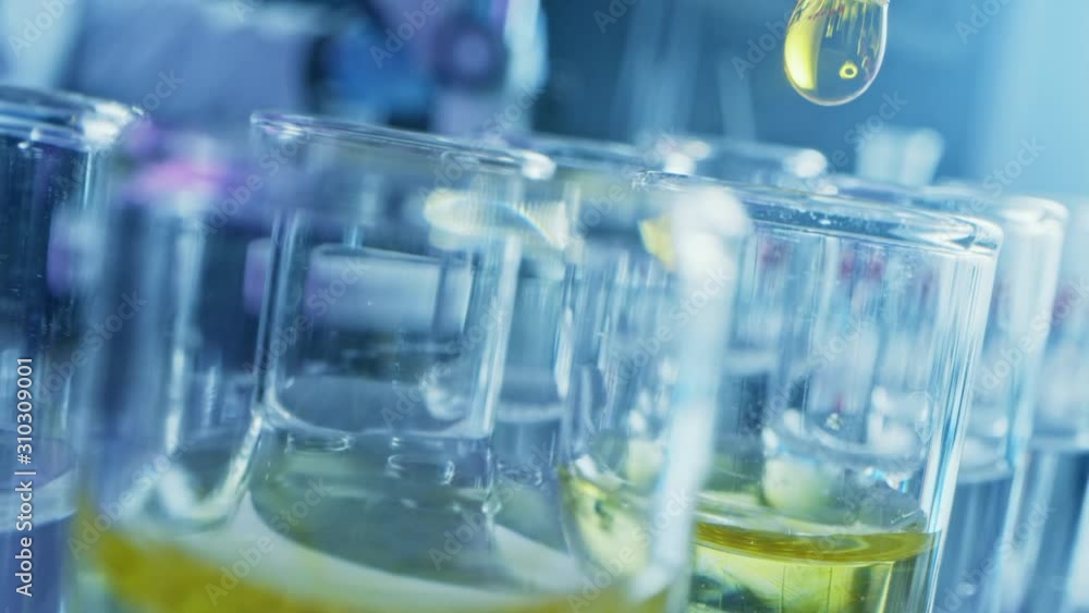 Pharmaceutics Laboratory: Pipette Dropping Yellow Liquid into Test ...