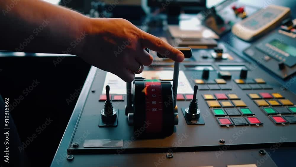 Hand of marine officer operationg bridge ship equipment of offshore dp ...