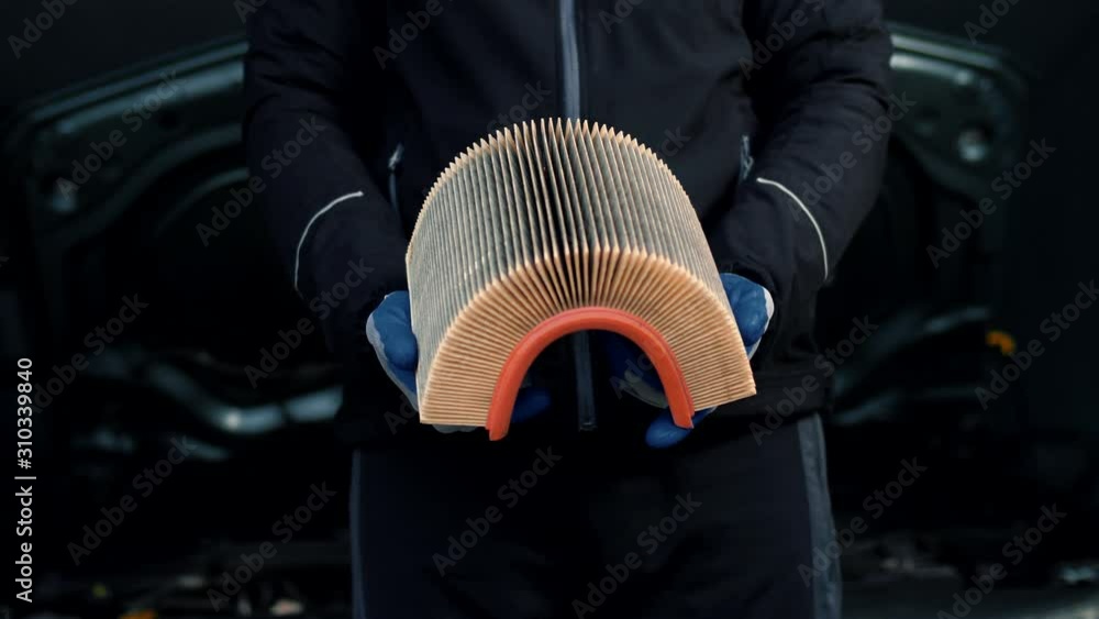 Dirty, old, damaged, aged, car air filter to be replaced in the hands ...