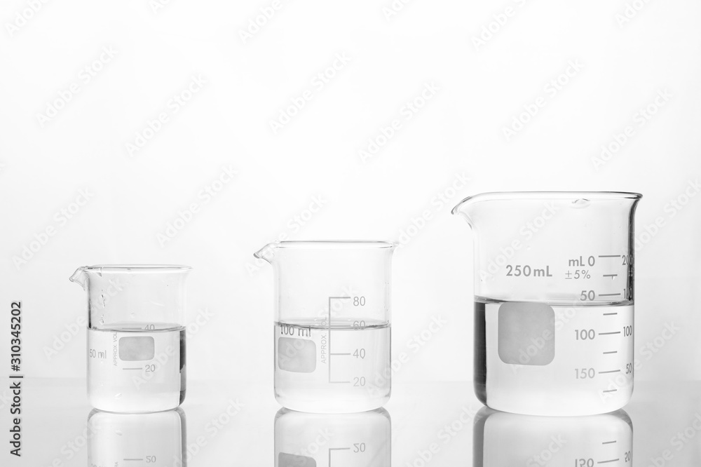 three size of glass beaker with water on white medical laboratory ...