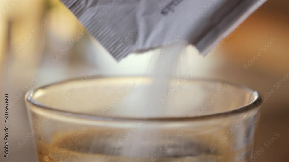 Male Hands open a Sugar Packet and Throwing Sugar into Cup inside a ...