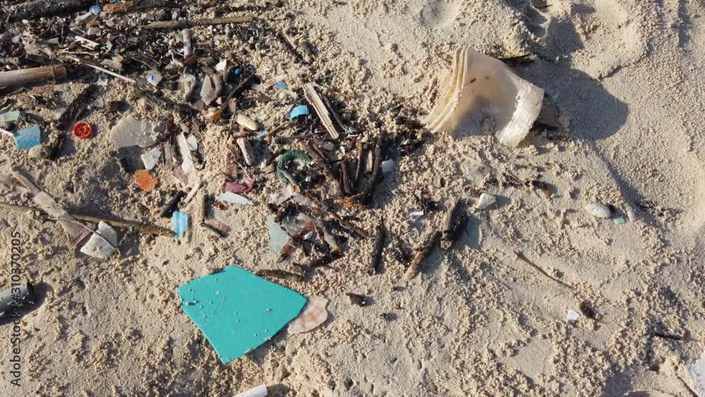 Environmental pollution. Sand beaches polluted with pieces of plastic ...
