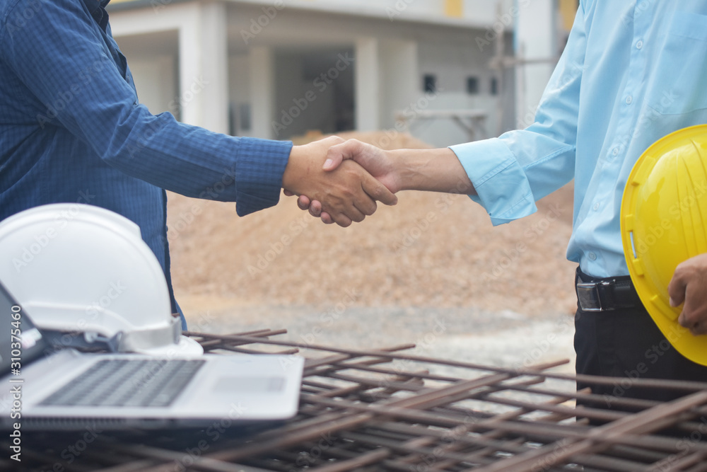 Businessman Shaking hands is a business promise in project building ...