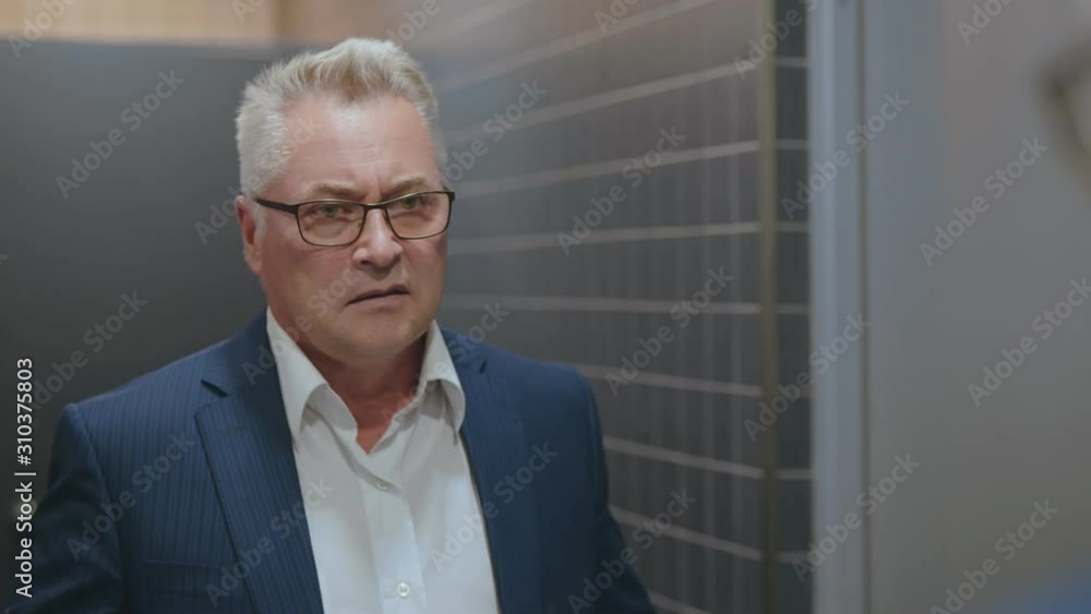 Senior business man in office bathroom in despair. Frustrated ...