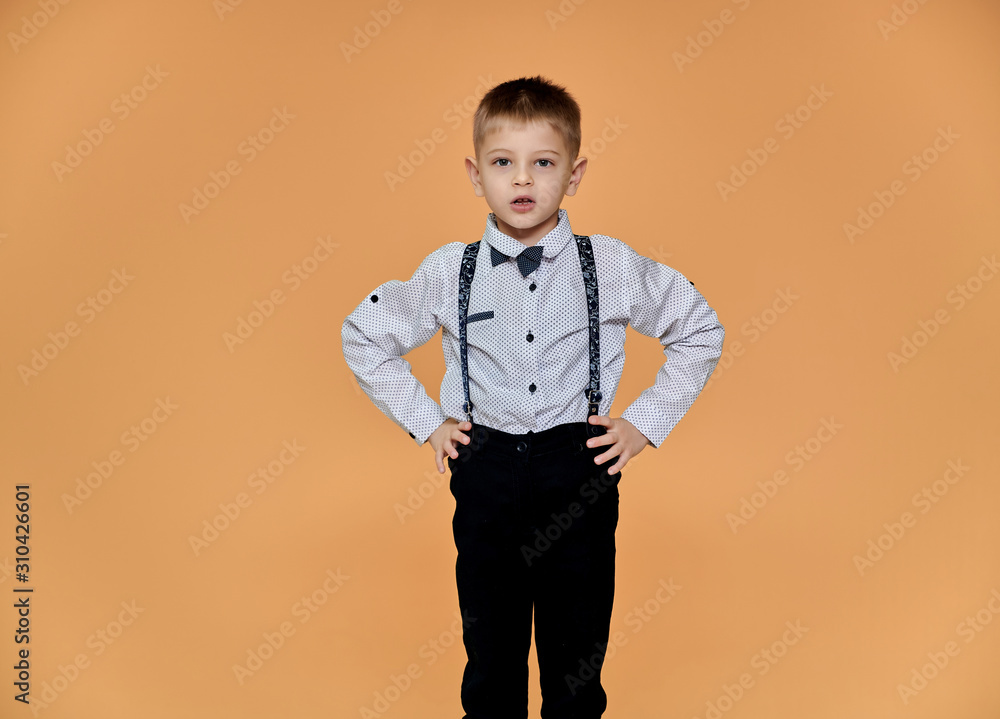 Portrait of a cute boy 10 years old schoolboy on a beige background in ...