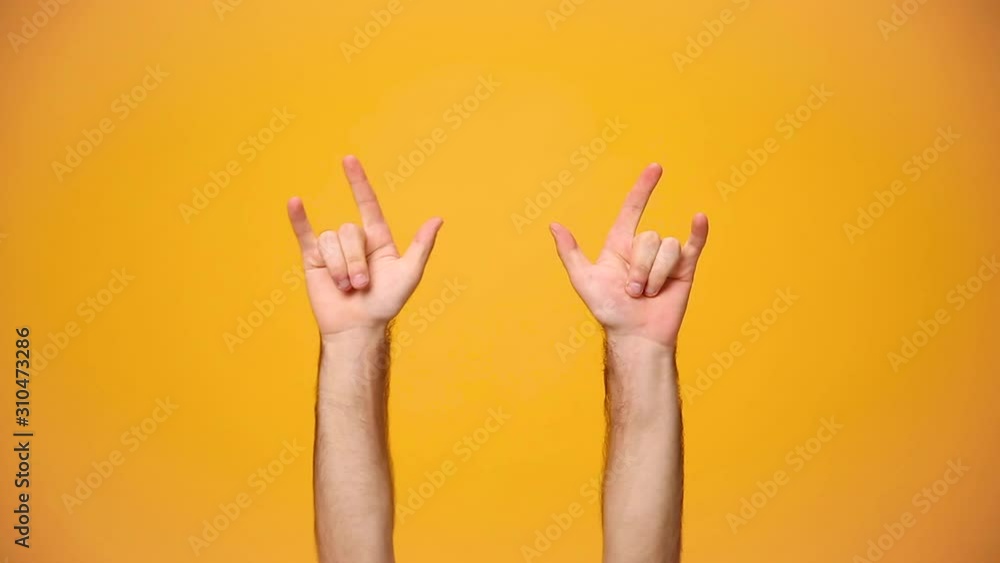 Man hold two hands depicting heavy metal rock sign, rock-n-roll horns ...