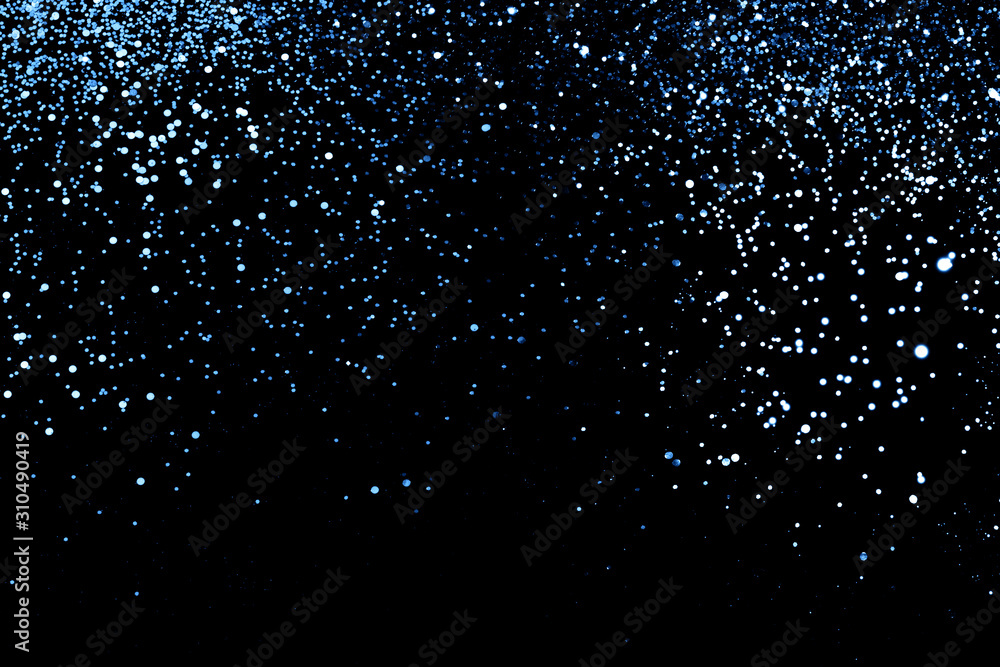 Splash of blue sparkles on black background. Stock Photo | Adobe Stock