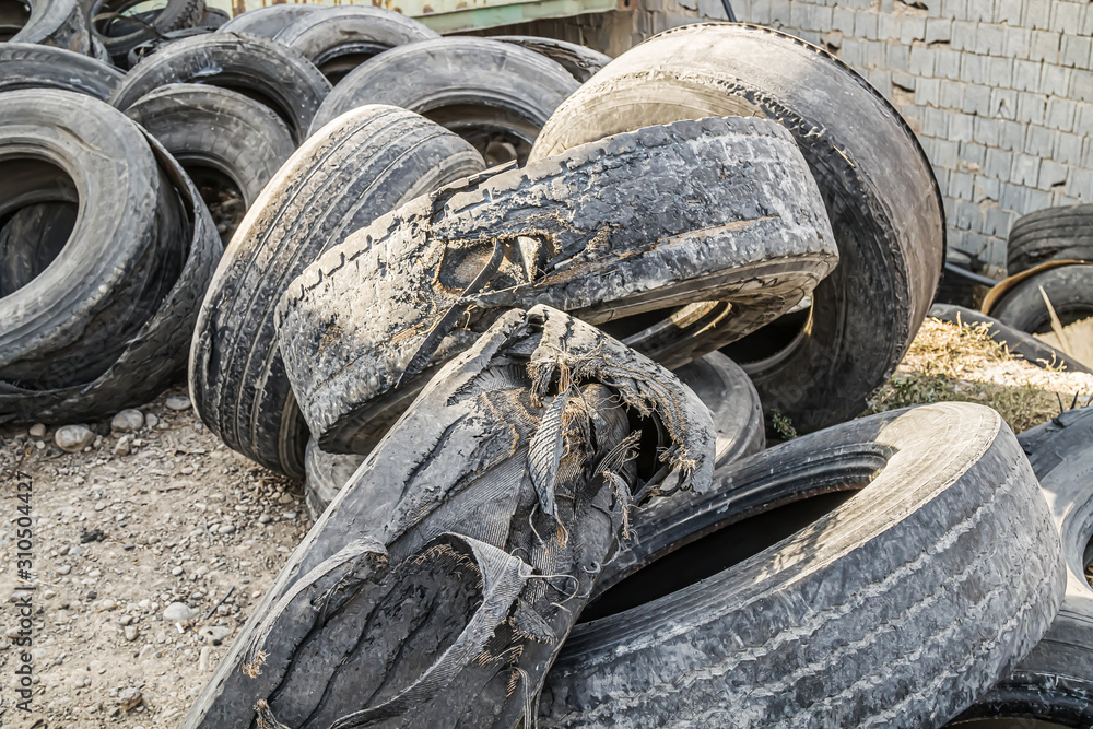 Garbage dump of old tires. Rubber recycling. Stock Photo | Adobe Stock