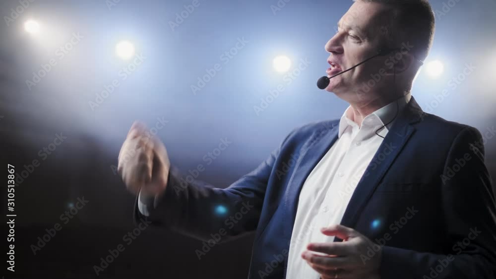 Showman. Middle Age Male entertainer, presenter or actor on stage. Arms ...