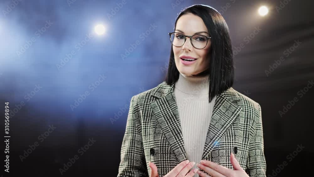 Show woman. Female entertainer, presenter or actor on stage. Arms to ...