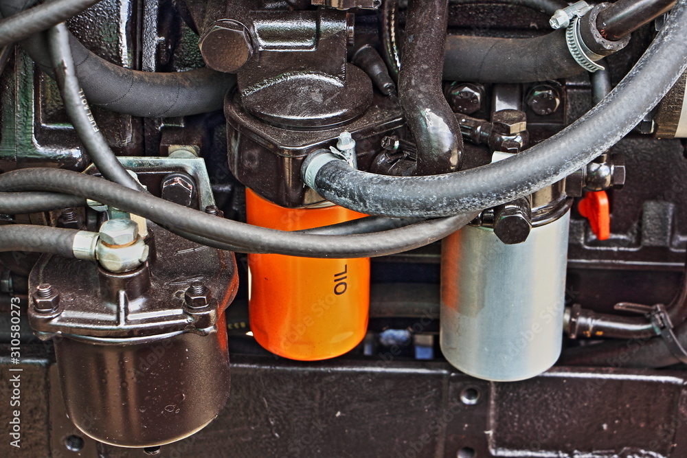 Fuel, oli and hydraulic fluid filters on modern tractor engine, farming ...