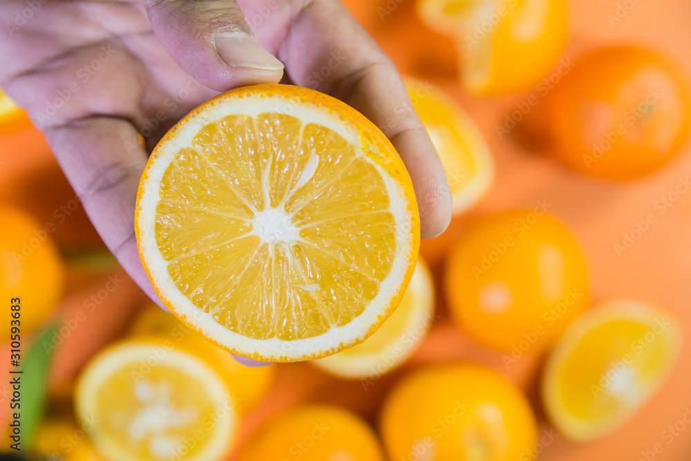 person holding fresh juicy and pulpy orange in hand top view with ...