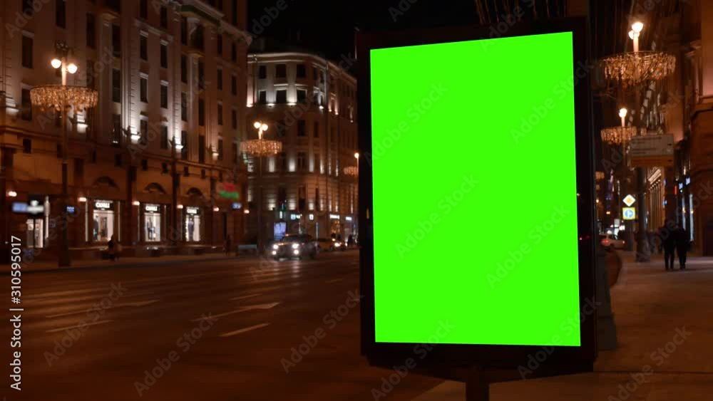 Winter evening. City street. close city light vitrine with empty green ...