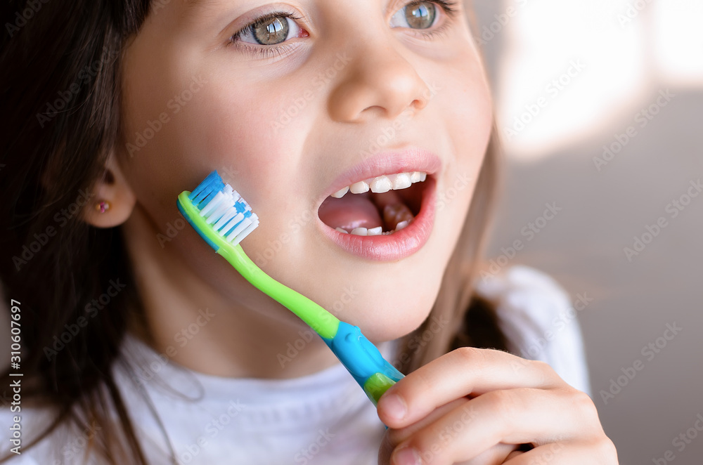 Little cute child showing her first baby tooth fall out in open mouth ...