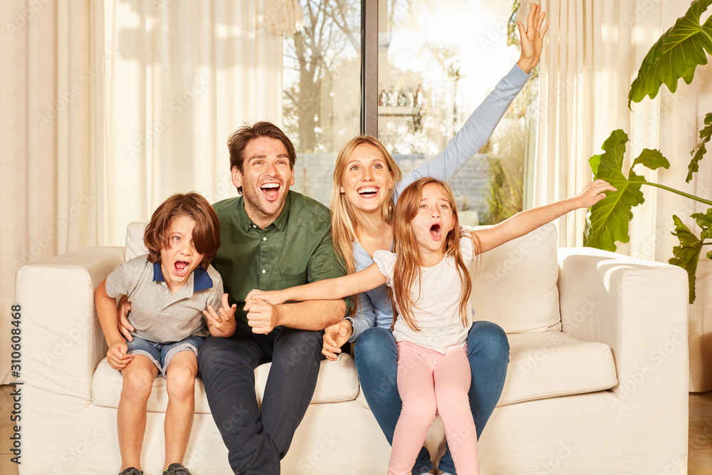 Parents and children cheerfully rejoice on the sofa Stock Photo | Adobe ...