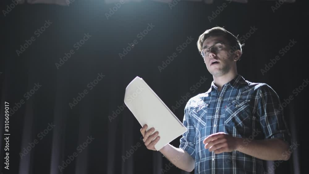 Medium shot of actors and actresses rehearsing a scene in a theater ...
