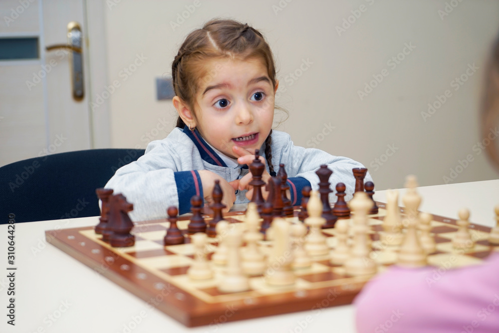 Little girl playing chess at home. Games and activities for children ...