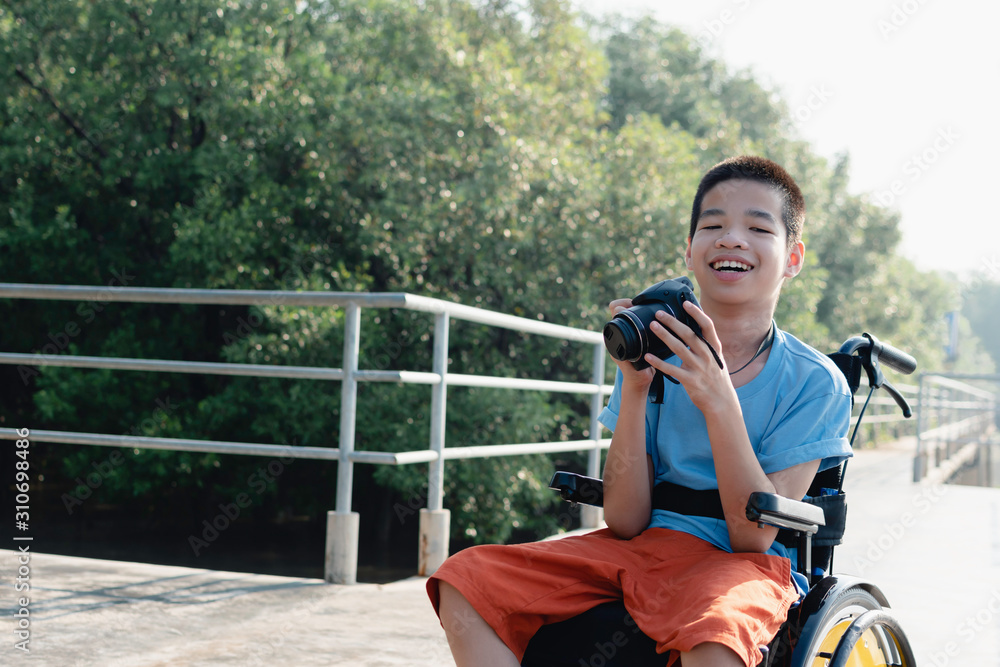 Poster Asian special child on wheelchair is happily on mangrove forest ...