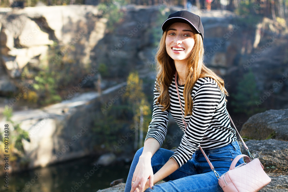 Beautiful young active woman on a background of a beautiful view of the ...