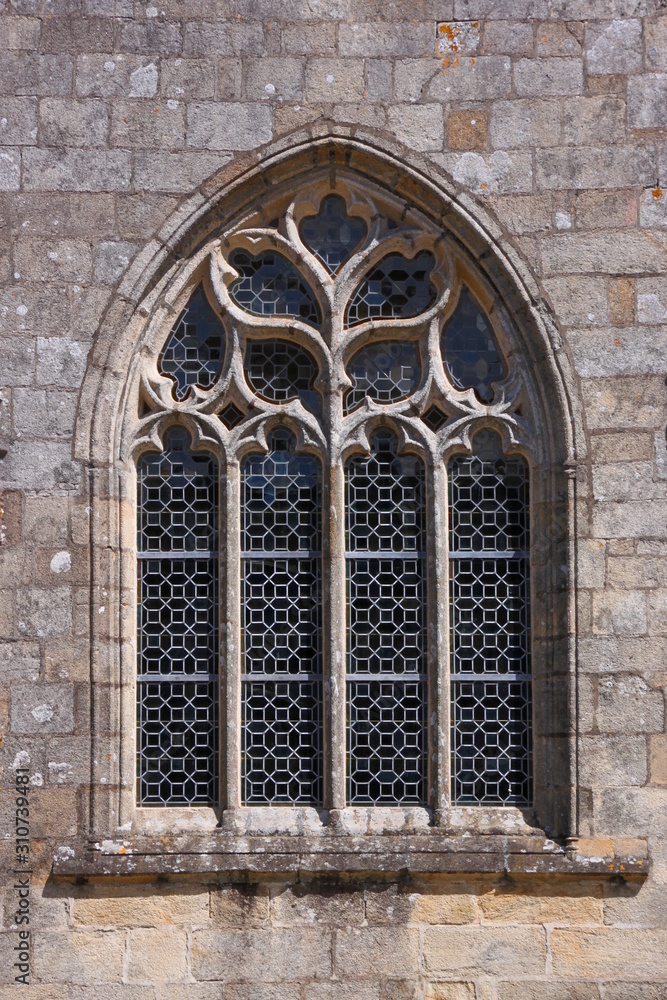 Pointed ogive arch with gothic window at Pont-Croix city church in Brittany, France Stock Photo ...