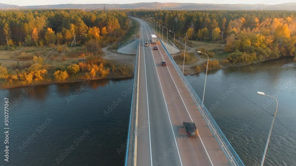 Aerial top view of business bridge over river, autumn landscape from ...