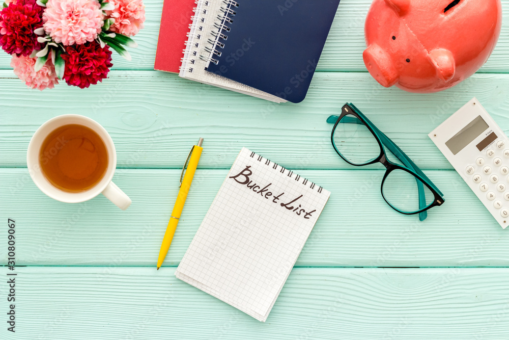 Bucket list. Blank notebook to write goals and wishes on green wooden ...