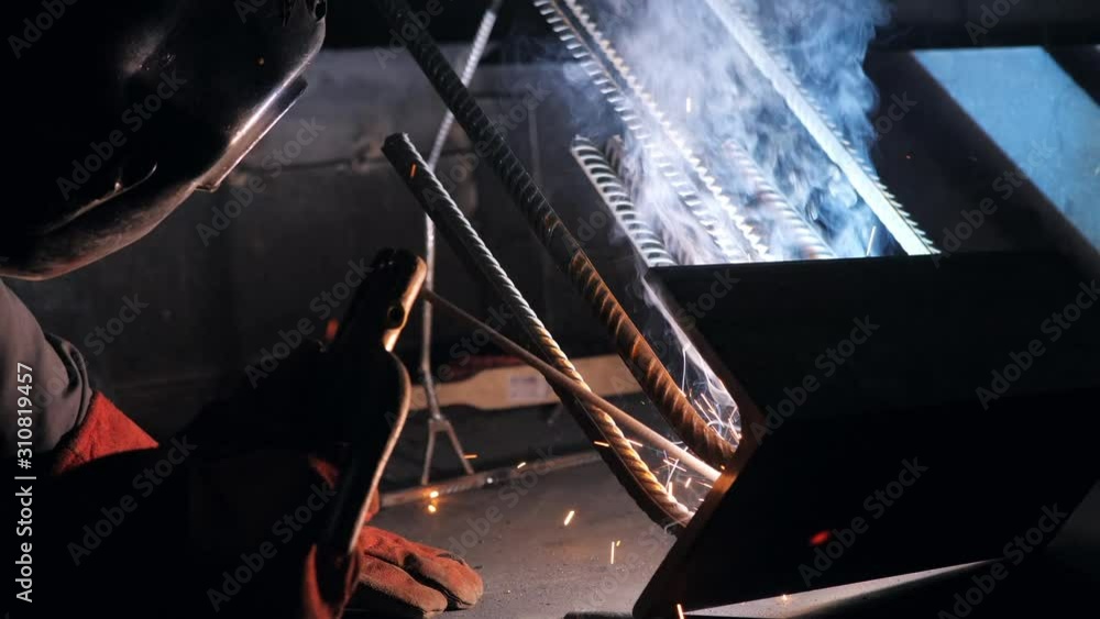 Welder working with welding machine. Bright flashes and smoke.. Welding ...