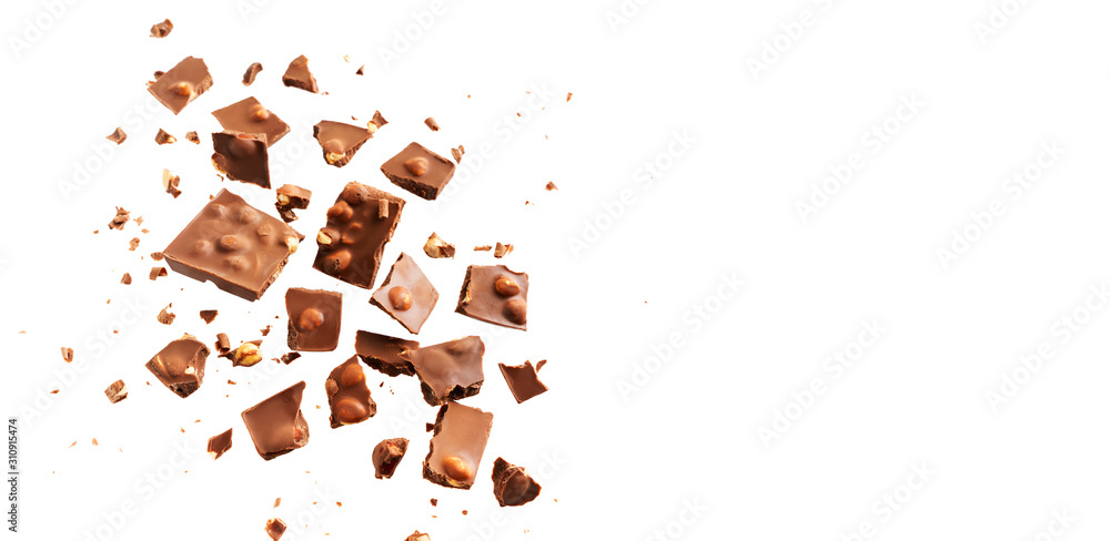 Flying in the air broken bar of milk chocolate with nuts and flakes ...