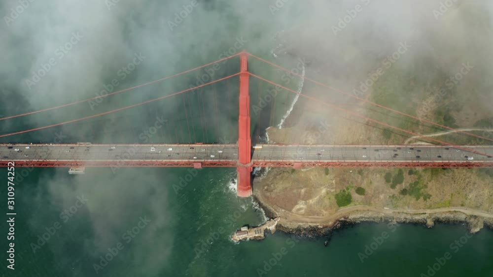 Top down footage over the Golden Gate Bridge with its red monumental ...