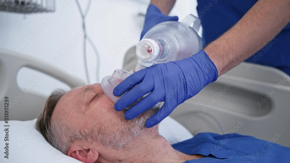 Defibrillation.Doctors save patient's life in clinic. Nurse and a ...