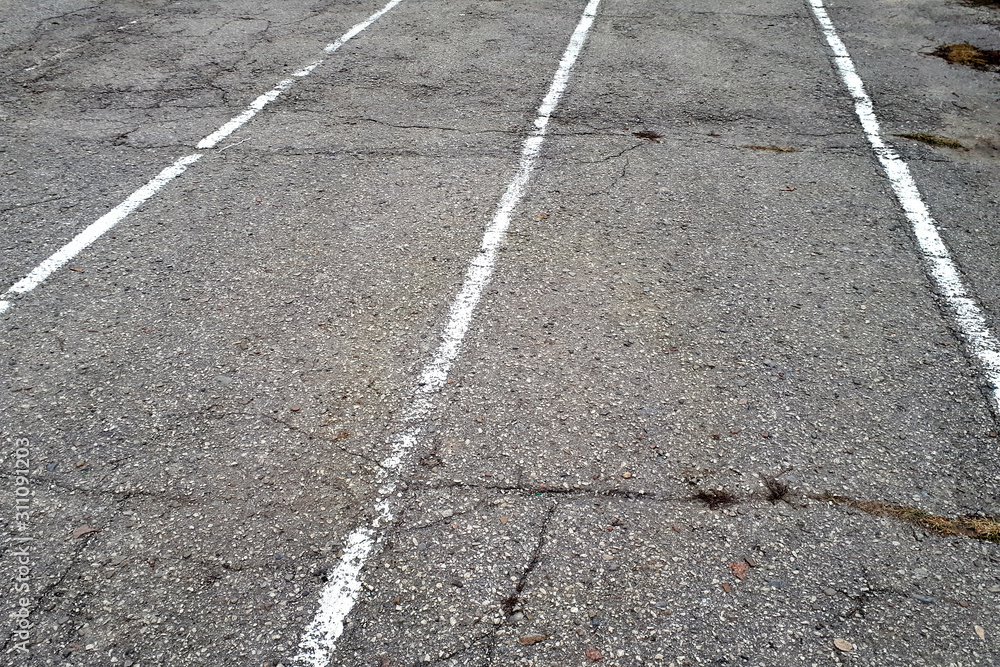 Cracked asphalt texture of a bike path in a public park. The texture of ...