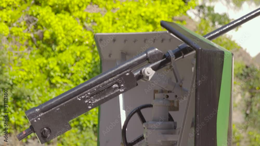 An extreme closeup shot with an upward tilting view of an artillery gun ...