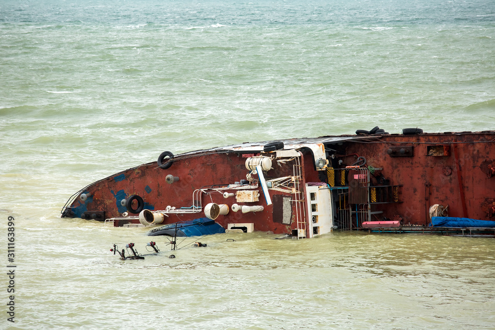 wrecked cargo ship captain bridge of a ship half sunken in sea water ...