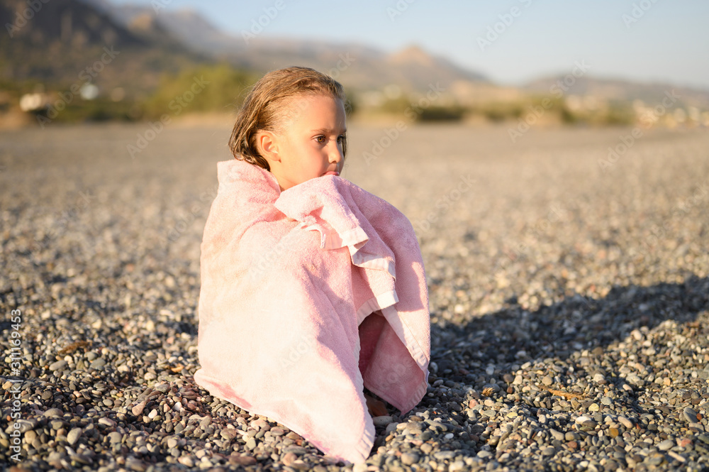 six year old little girl resting on the sea beach after swimming Stock ...