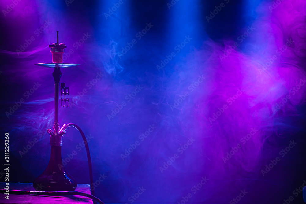 The classic hookah. Beautiful background, with colored rays of light ...