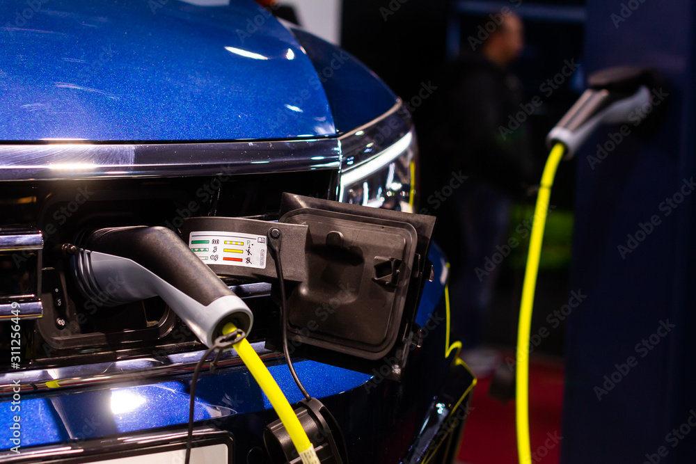 Charging an electric or hybrid PHEV car with the power cable supply ...