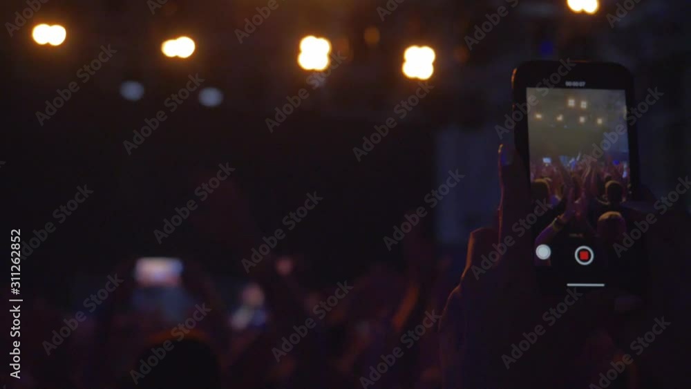 Audience at indoor music festival. Crowd enjoy rap concert, dancing in ...